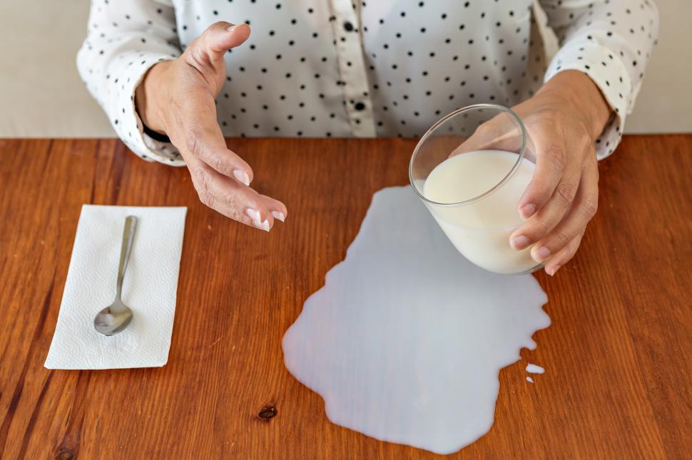 Free Stock Photo of Woman spills a glass of milk on the table ...