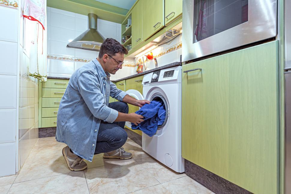Free Stock Photo of adult man loading the washing machine | Download ...
