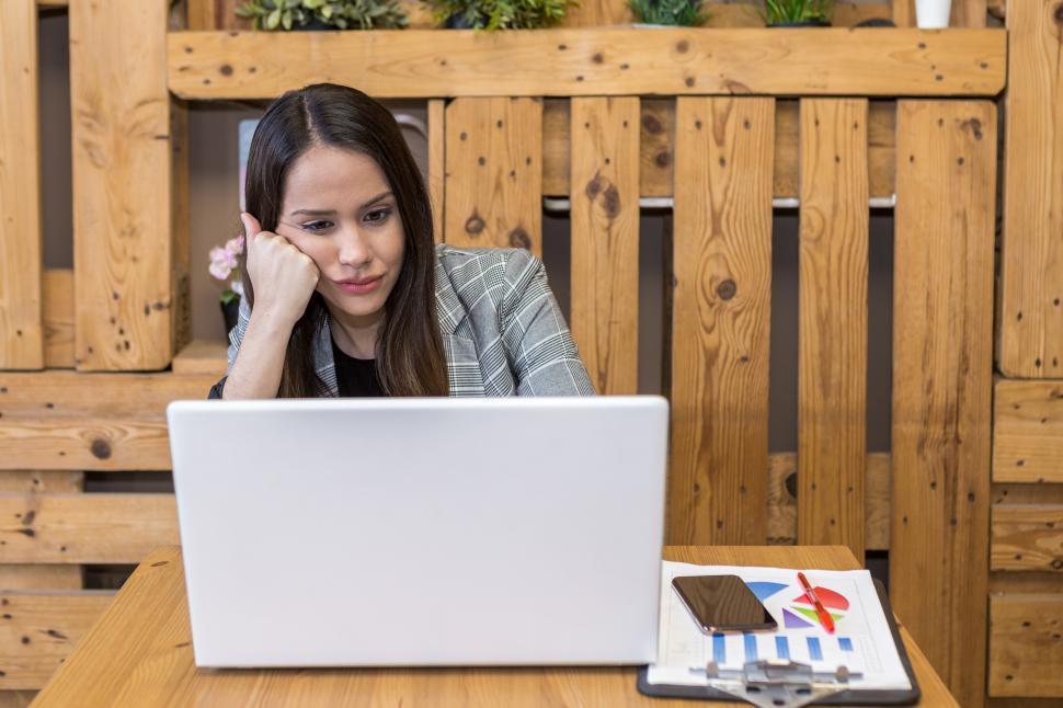 Free Stock Photo of Bored woman leaning on hand while using laptop ...