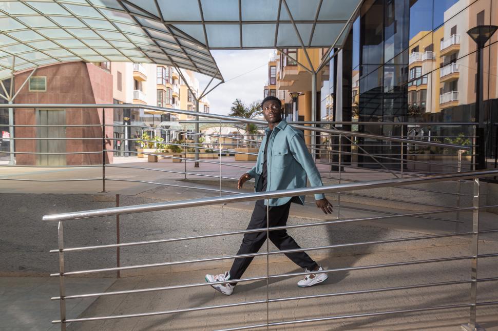 Free Stock Photo of Cool African American guy walking near contemporary ...
