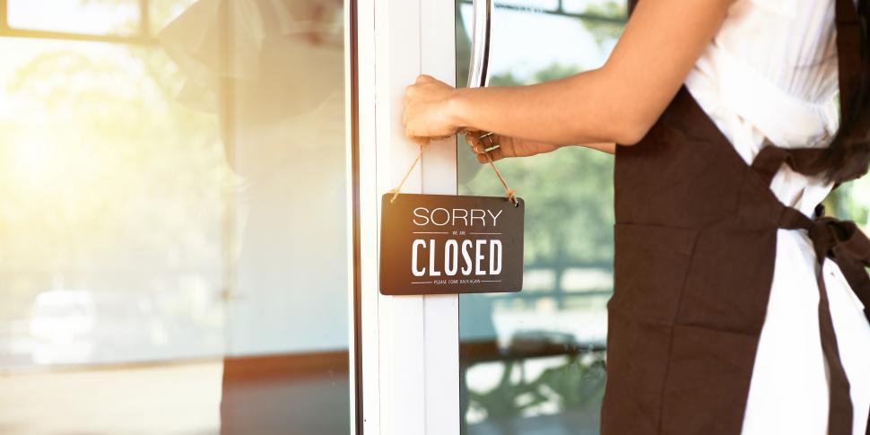 Free Stock Photo of The shopkeeper hanging a CLOSED sign on the door ...