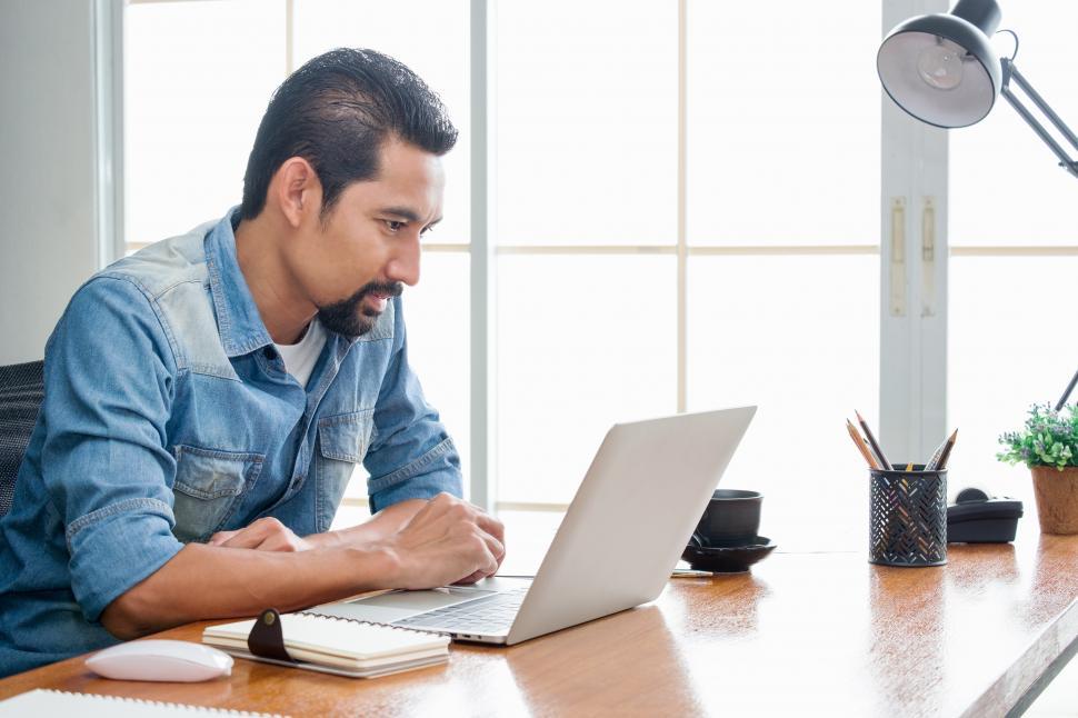 Free Stock Photo of Man working at a computer, sitting at a table ...