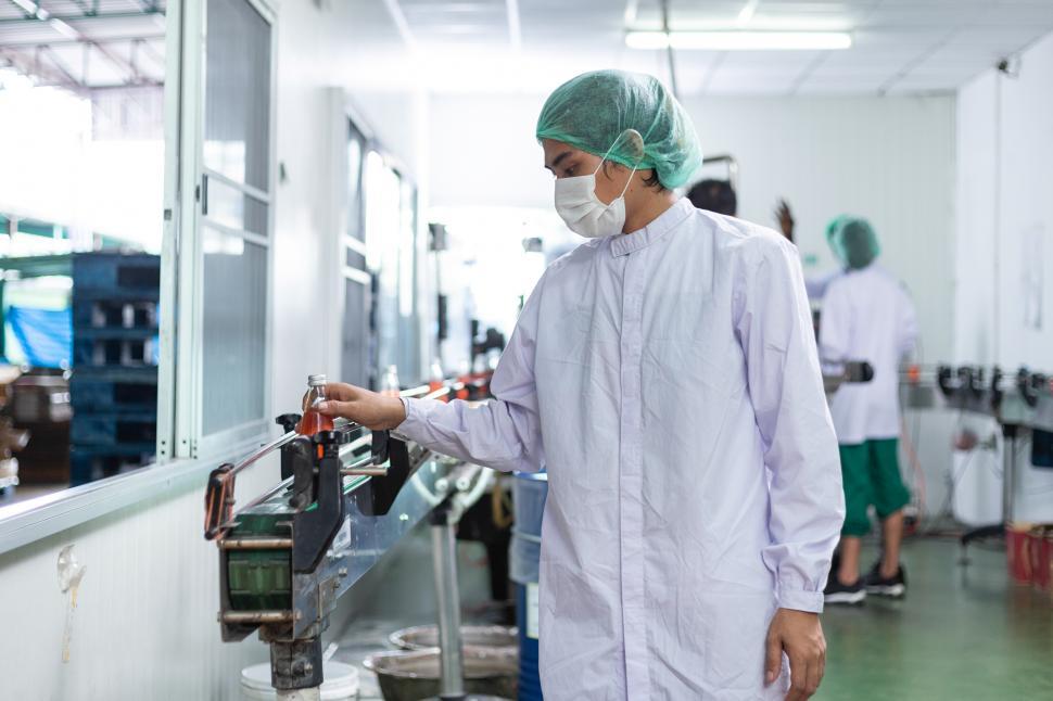 Free Stock Photo of Male factory putting bottle into production line ...