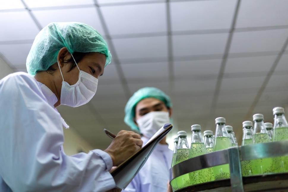 Free Stock Photo of Male worker checking drink bottle on bottling ...