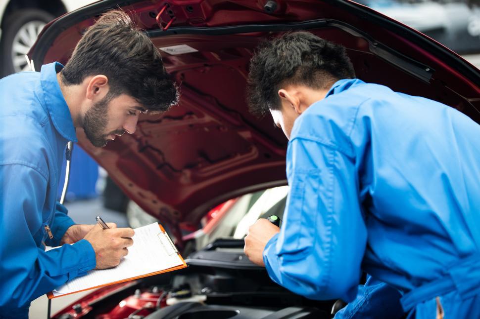 Free Stock Photo of Mechanic checking damage part under car hood ...