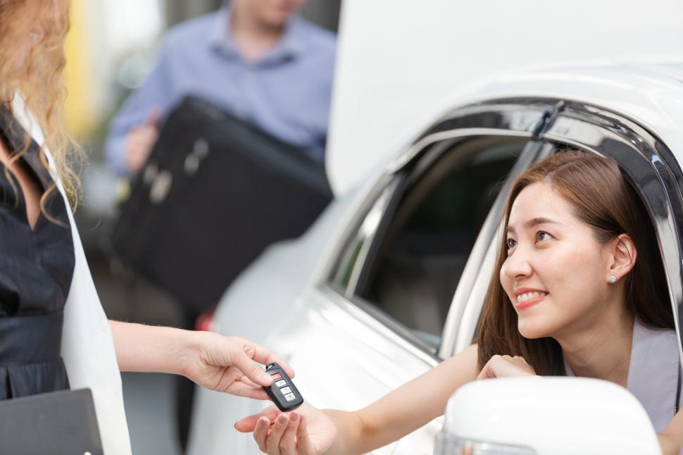 Free Stock Photo of Smiling woman customer receiving remote key from ...