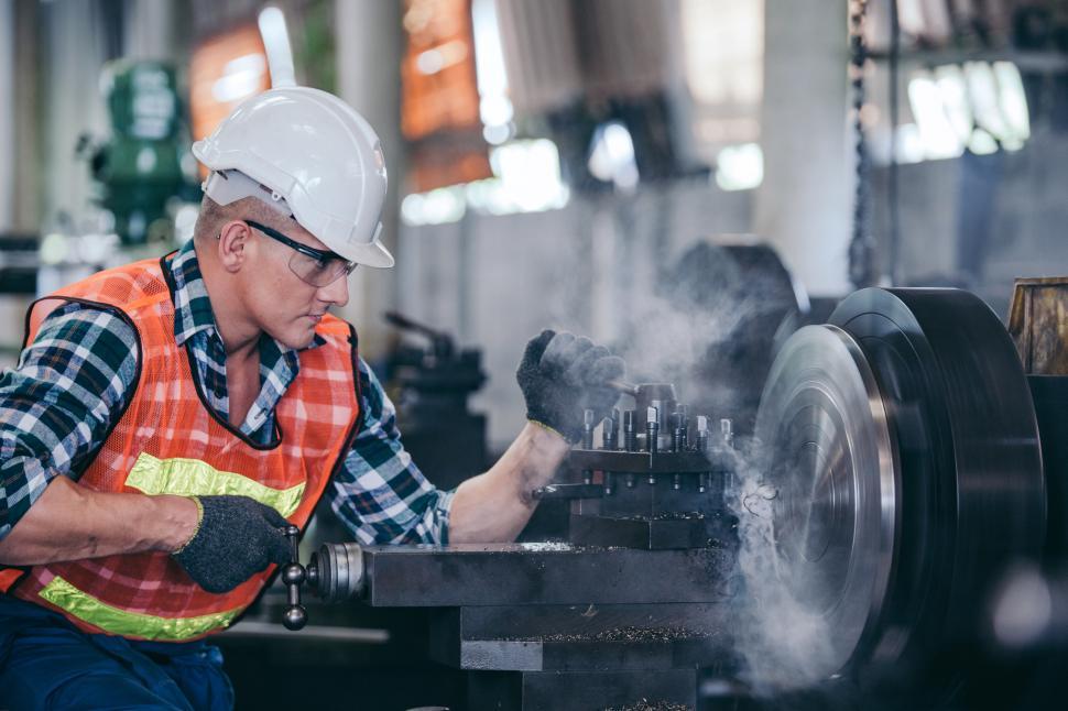 Free Stock Photo of Engineer metalworker working on lathe machine ...