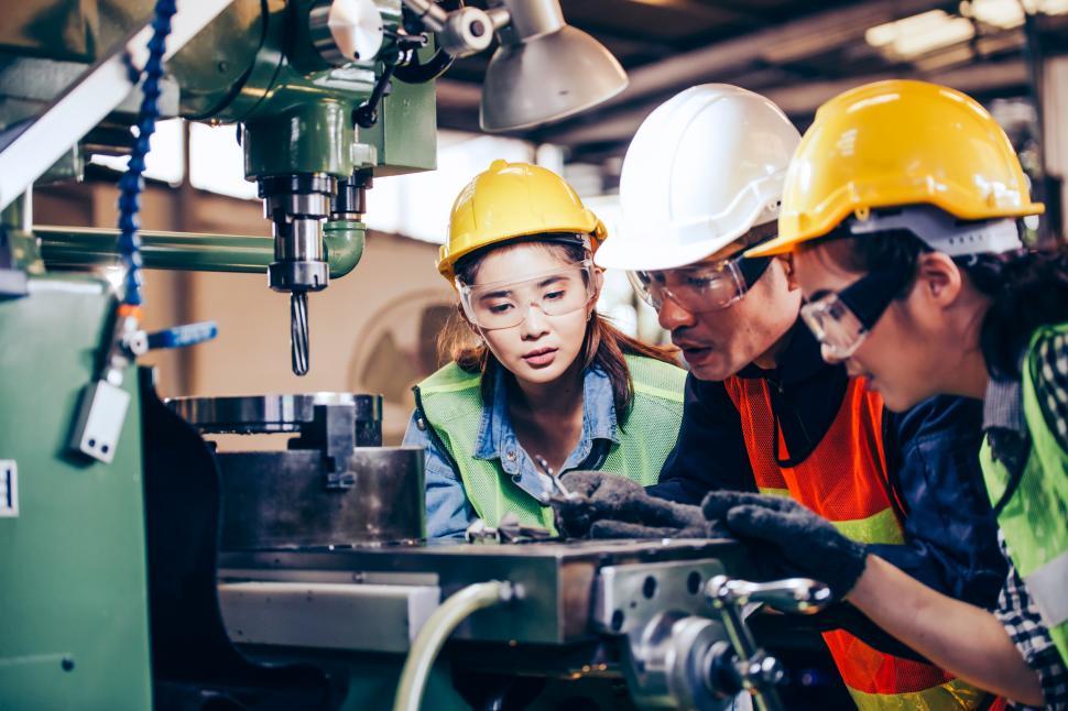 Free Stock Photo of Male engineer teaching female trainee at a factory ...