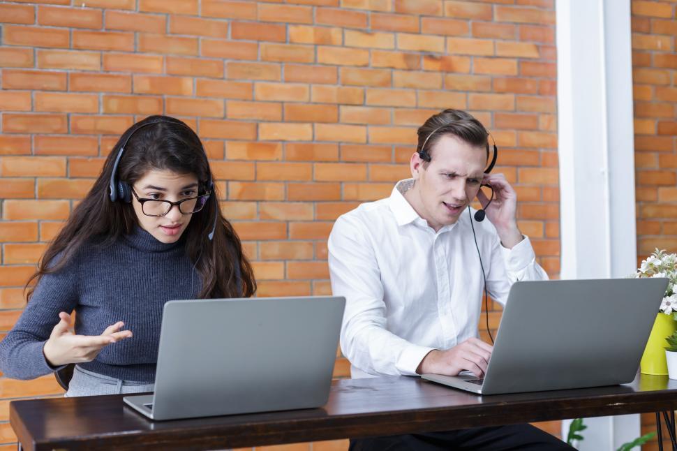 Free Stock Photo of Two people working to answer phones and provide ...