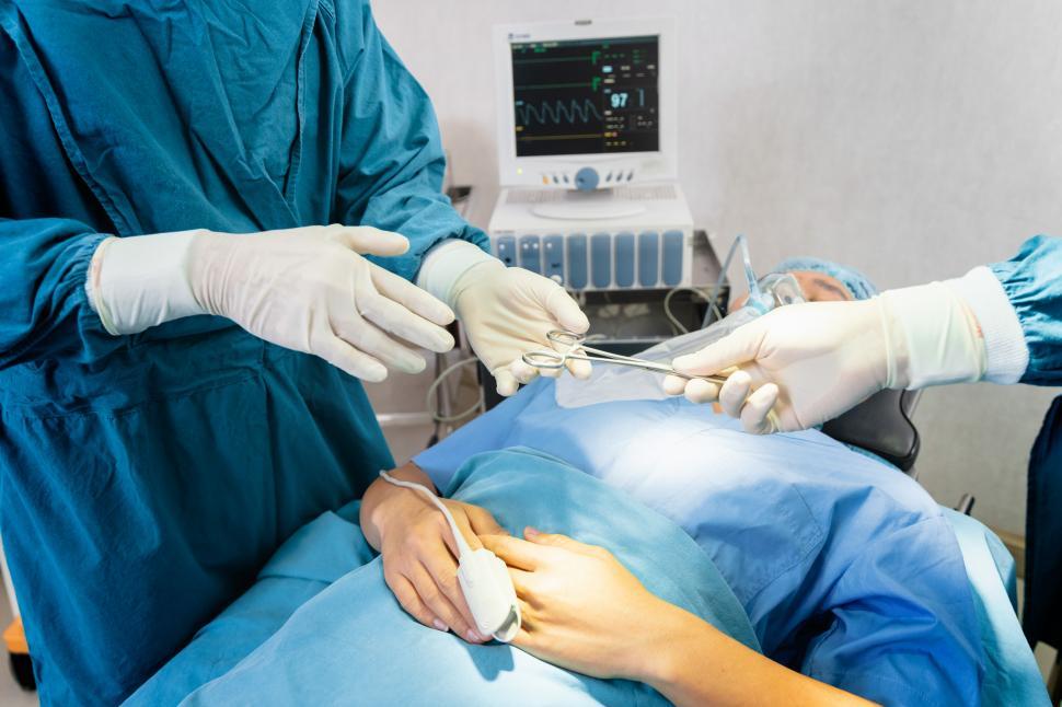 Free Stock Photo of Assistant Hands out Instruments to Surgeons During ...