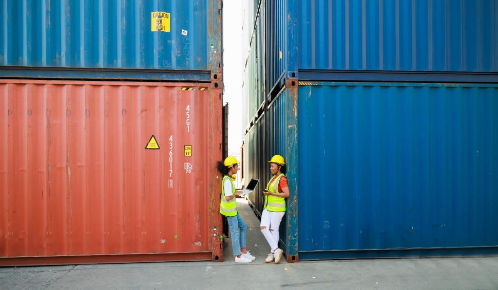 Free Stock Photo of Two Black female dock workers relax and talk ...