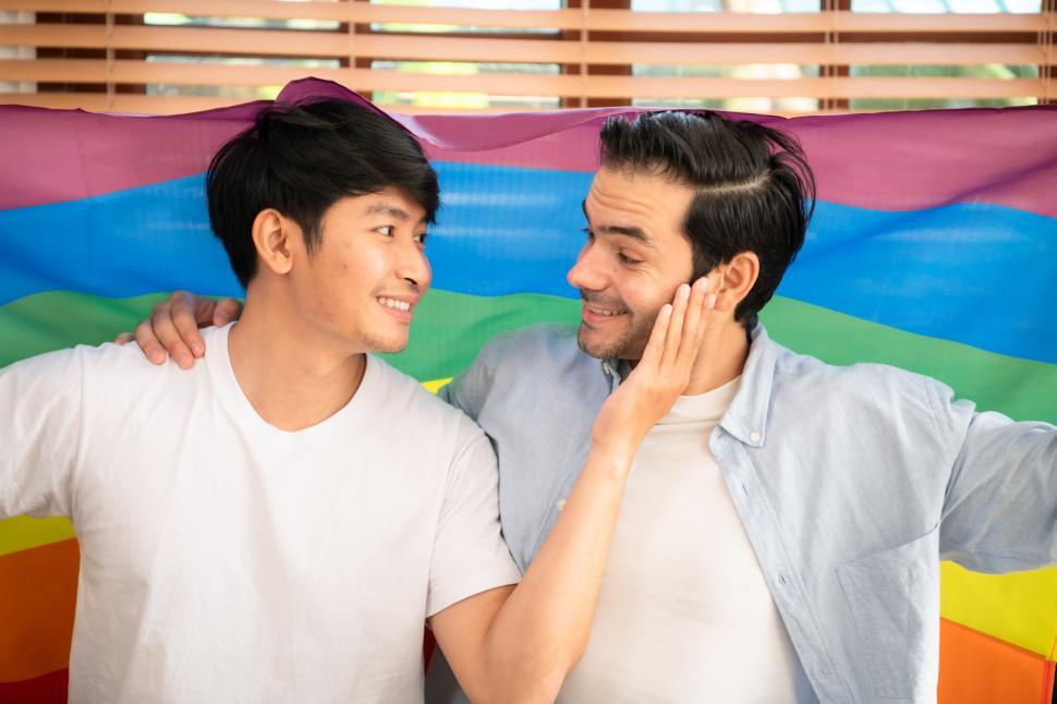 Free Stock Photo of Two men sitting in front of a rainbow pride flag ...