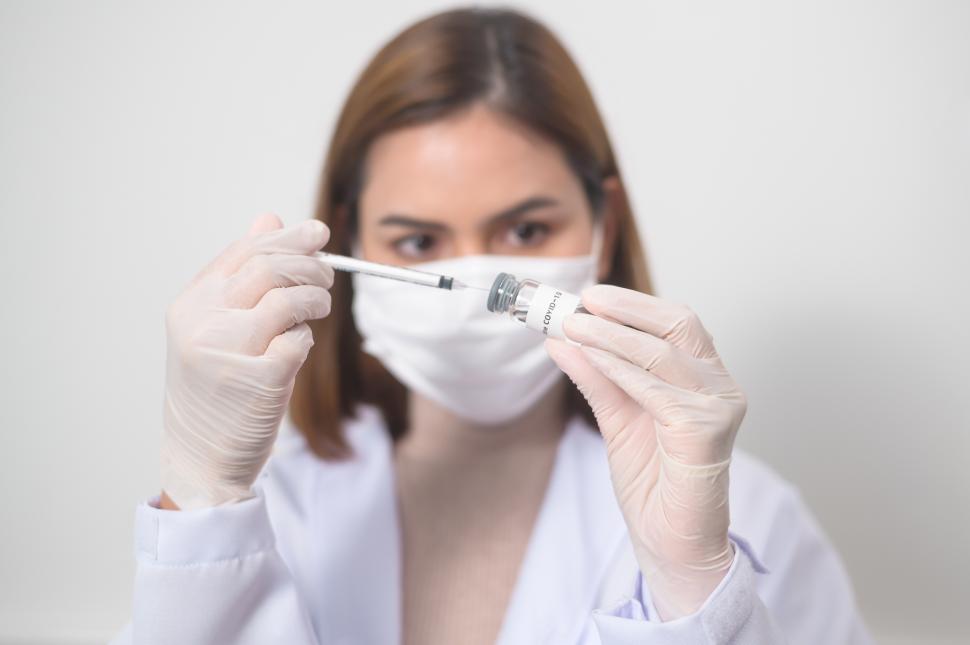Free Stock Photo of Young female doctor extracting a dose with syringe ...