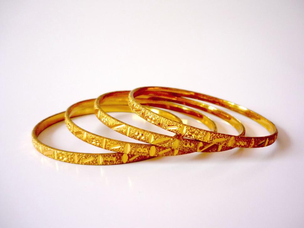 Free Stock Photo of Stack of Gold Colored Bangles on White Background ...