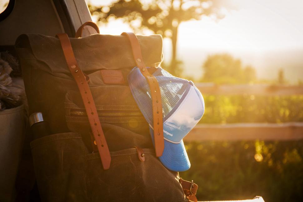 Free Stock Photo of A backpack with a cap and a baseball cap on it ...