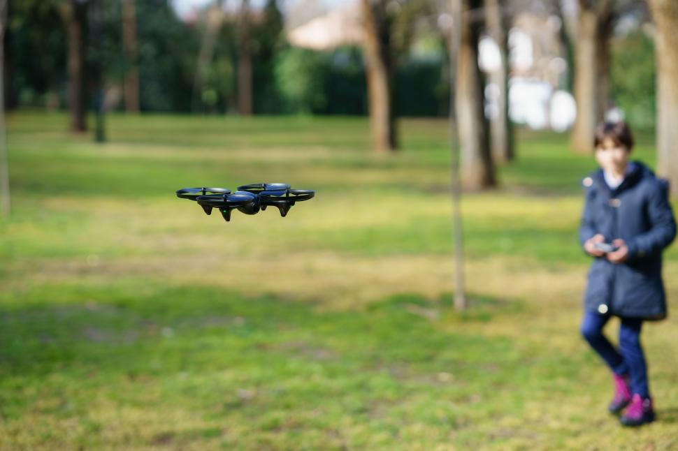 Free Stock Photo of Nine-year-old girl operating toy drone flying by ...