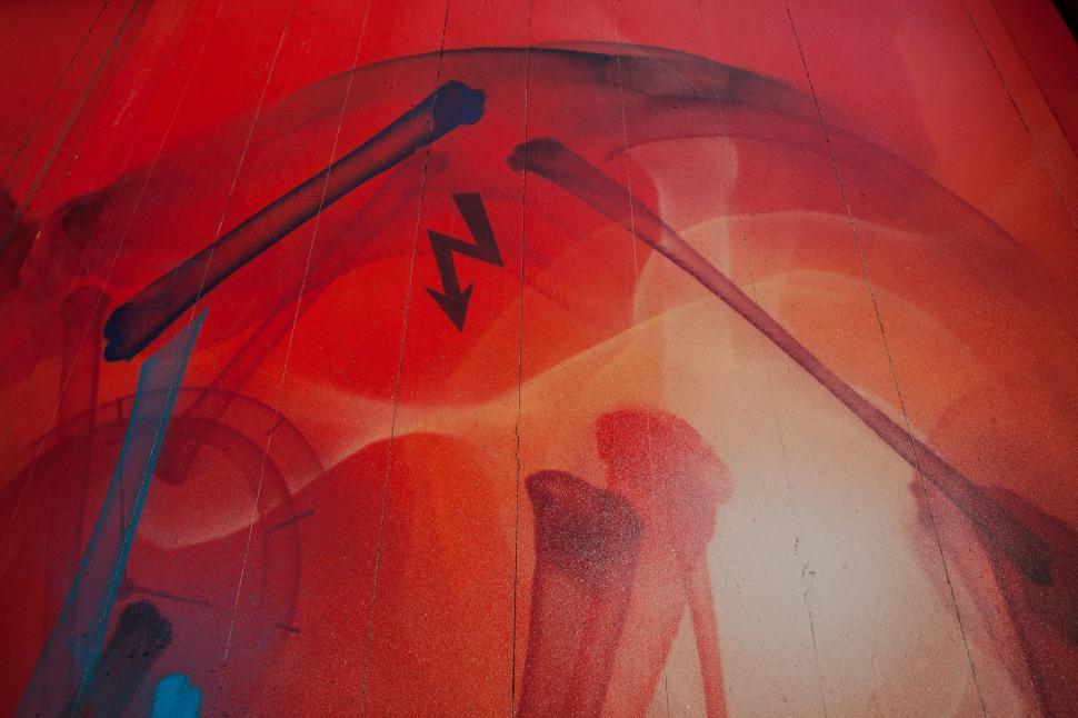 Free Stock Photo of A red and blue wall with a painting of bones and ...