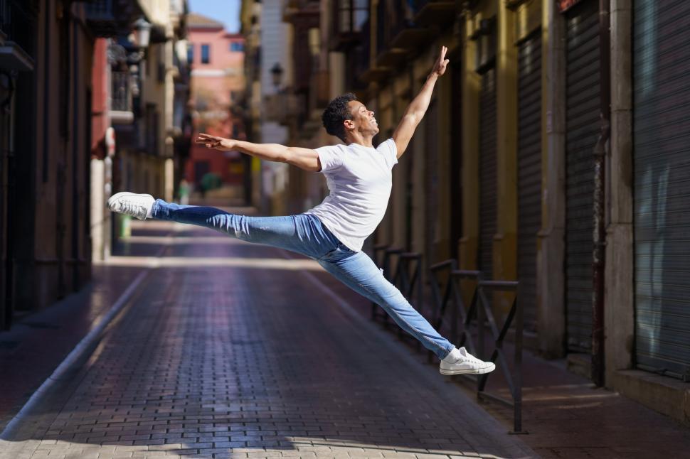 Free Stock Photo of Black athletic man doing an acrobatic jump outdoors ...