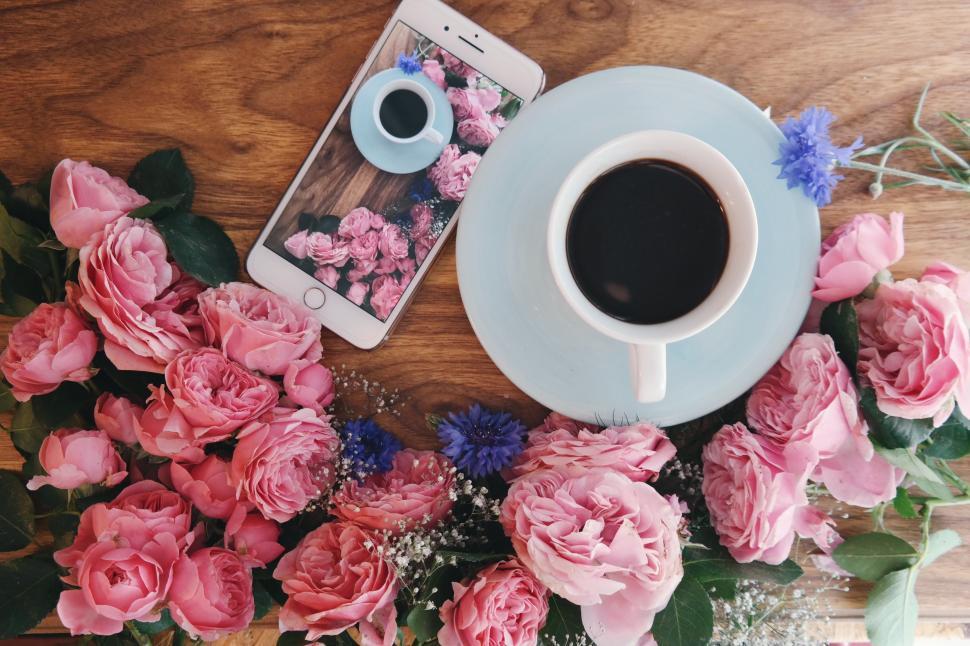 Free Stock Photo of A cup of coffee and a phone next to flowers ...