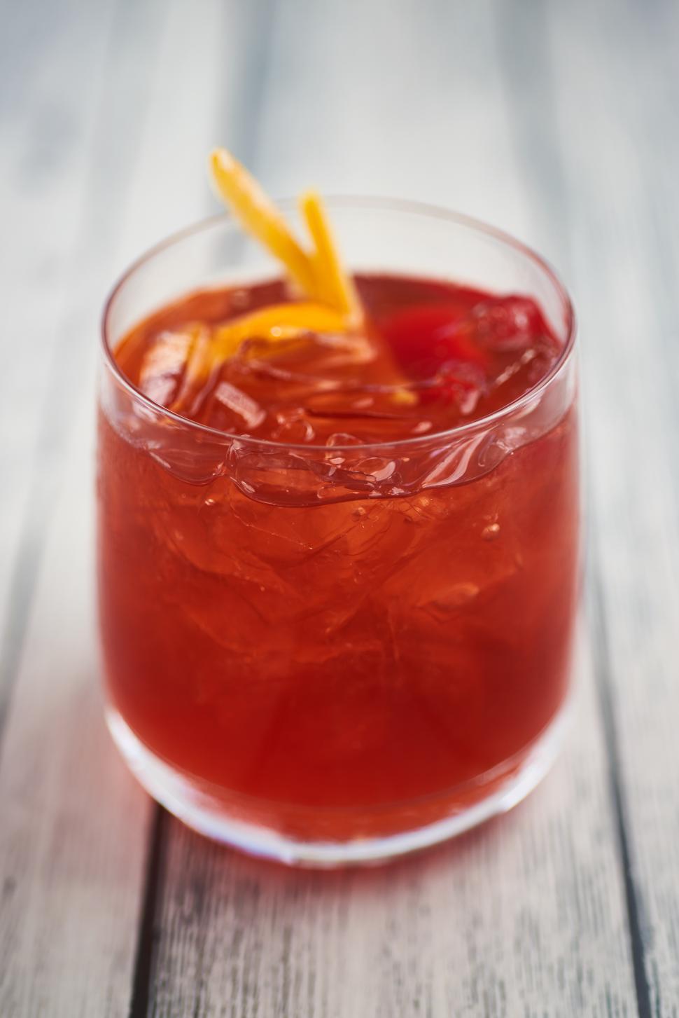 Free Stock Photo of A glass of red liquid with a slice of orange peel ...