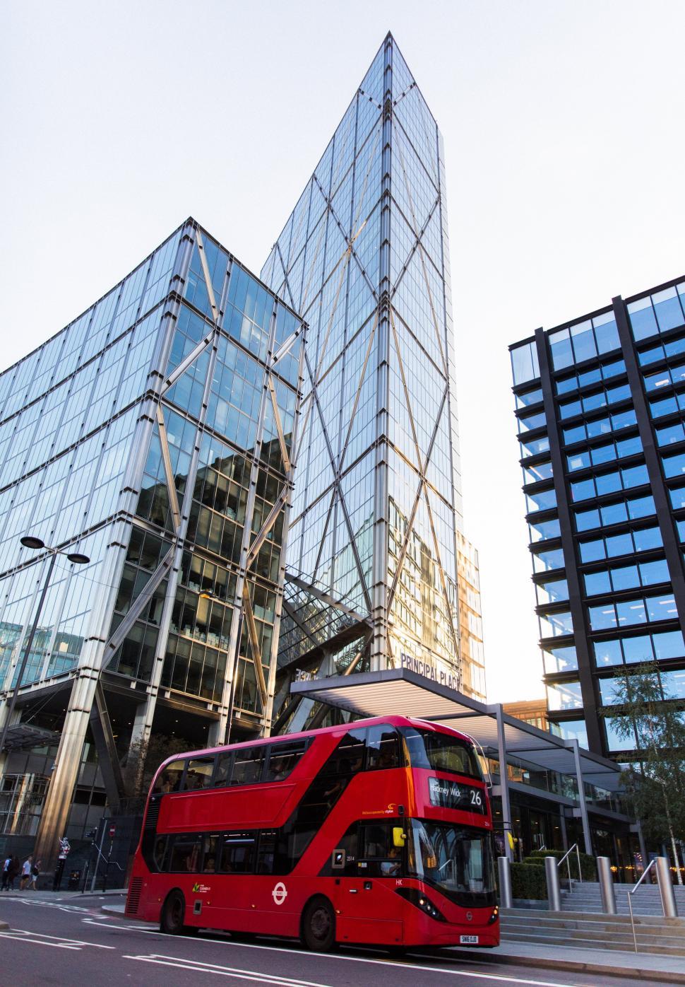 Free Stock Photo of A double decker bus in front of a tall building ...