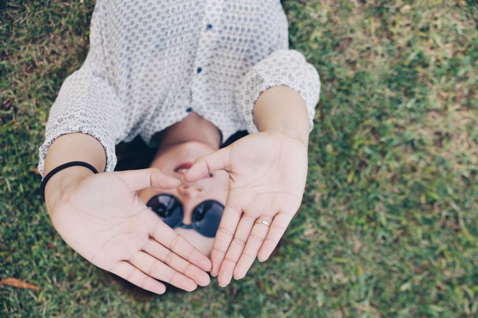 Free Stock Photo of A person lying on the grass with their hands in ...