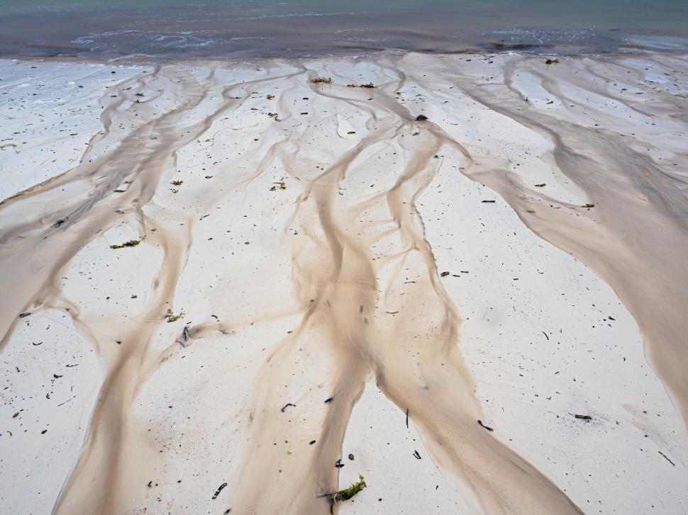 Free Stock Photo of A sandy beach with water flowing through it ...