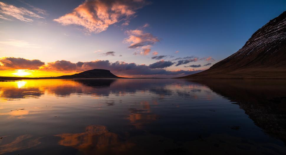 Free Stock Photo of A body of water with a hill in the distance ...
