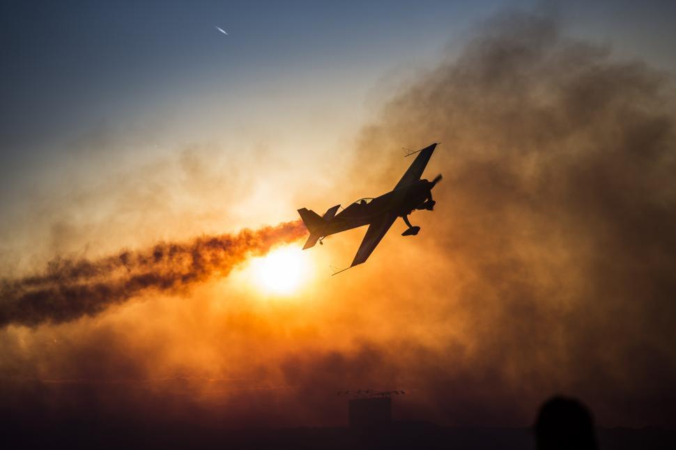 Free Stock Photo of A plane flying in the sky with smoke coming out of ...