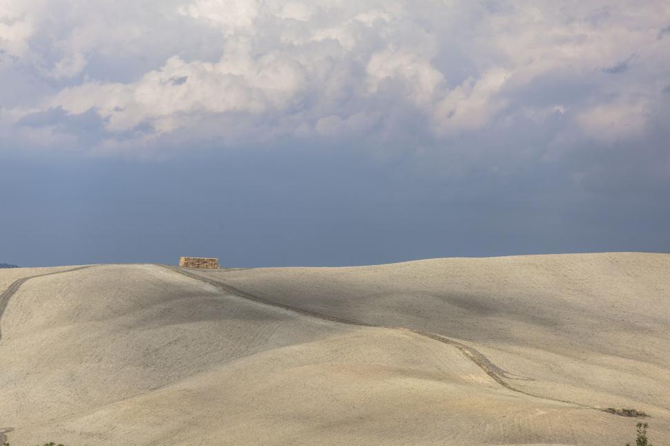 Free Stock Photo of A large sandy hill with a building on top ...