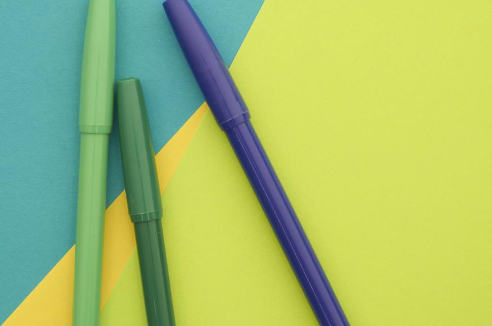 Free Stock Photo of A group of markers on a yellow and green background ...