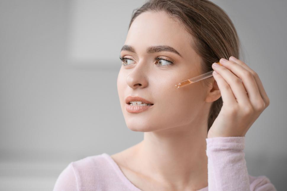 Free Stock Photo of A woman holding a dropper over her face | Download ...