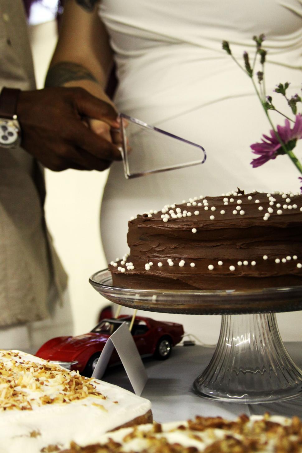 Free Stock Photo of Person slicing chocolate cake on table | Download ...