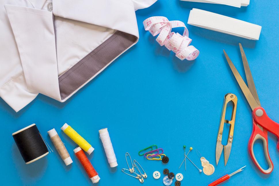 Free Stock Photo of Tailoring tools neatly arranged on blue surface ...