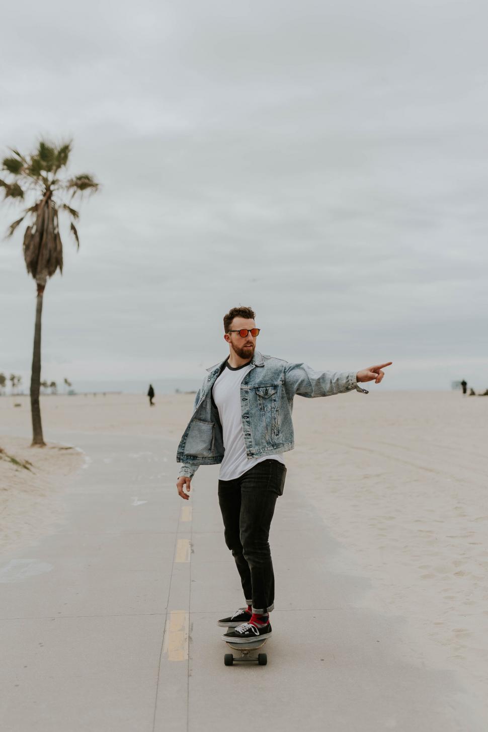 Free Stock Photo of Man skateboarding on beach promenade | Download ...