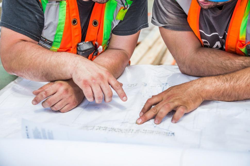 Free Stock Photo of Engineers planning over a blueprint at work ...