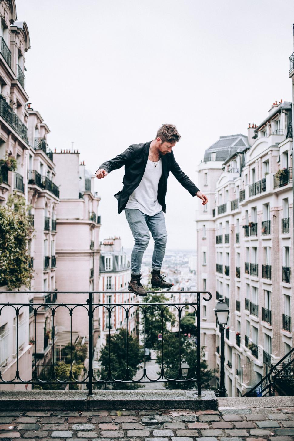 Free Stock Photo of Man balancing on railing in urban setting ...
