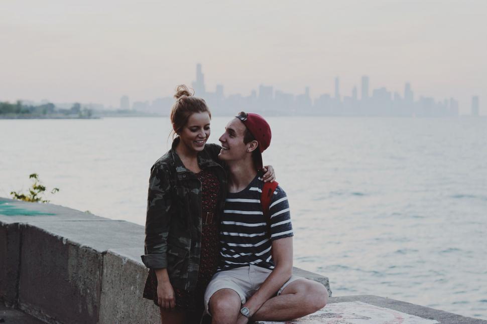Free Stock Photo of Couple kissing on lakefront with cityscape ...