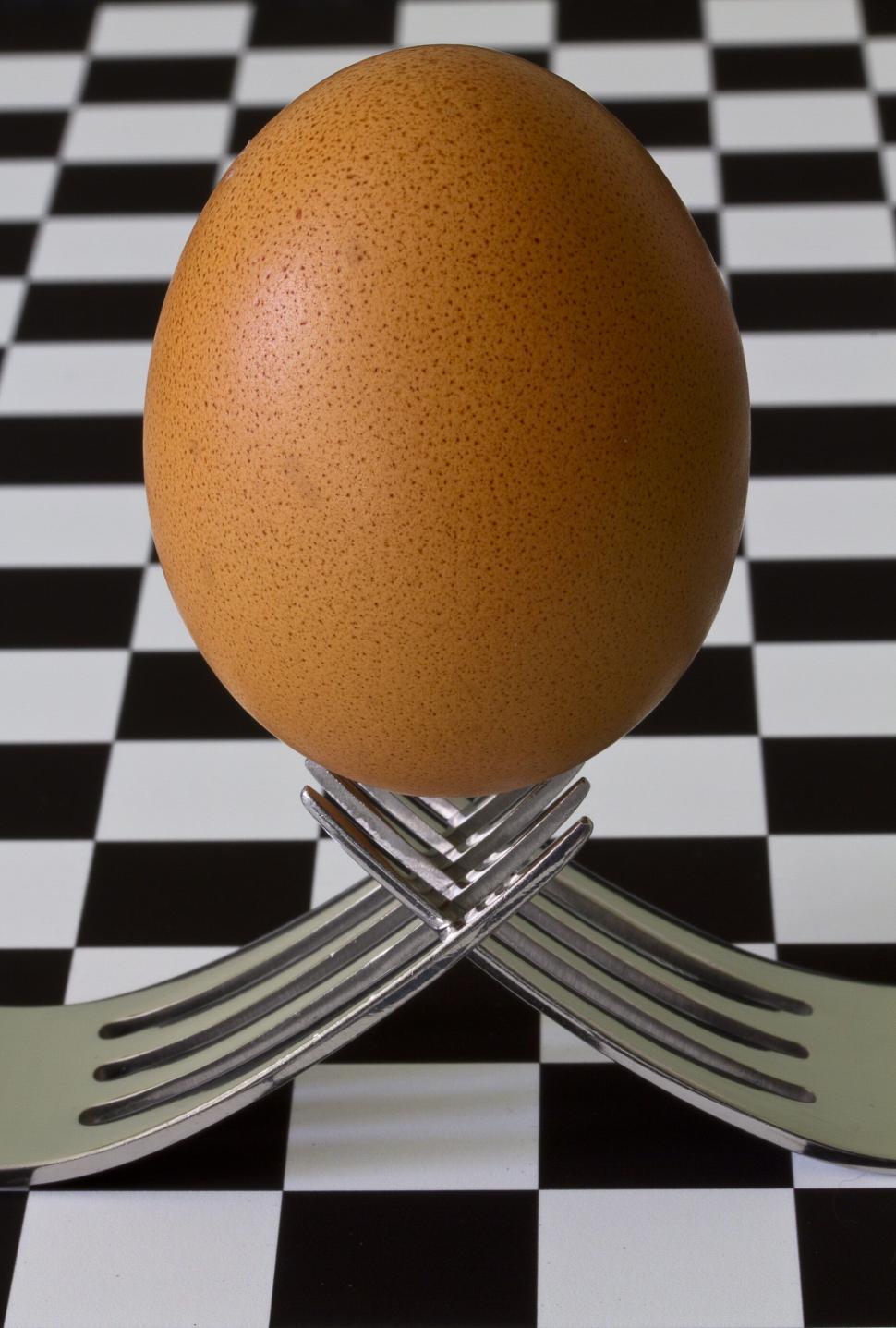 Free Stock Photo of Egg balanced on crossed forks over checkered ...