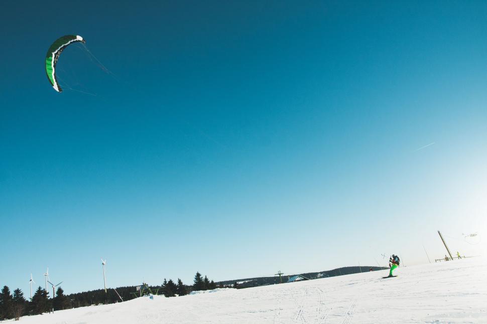Free Stock Photo of Snowkiter gliding on snowy mountain slope ...