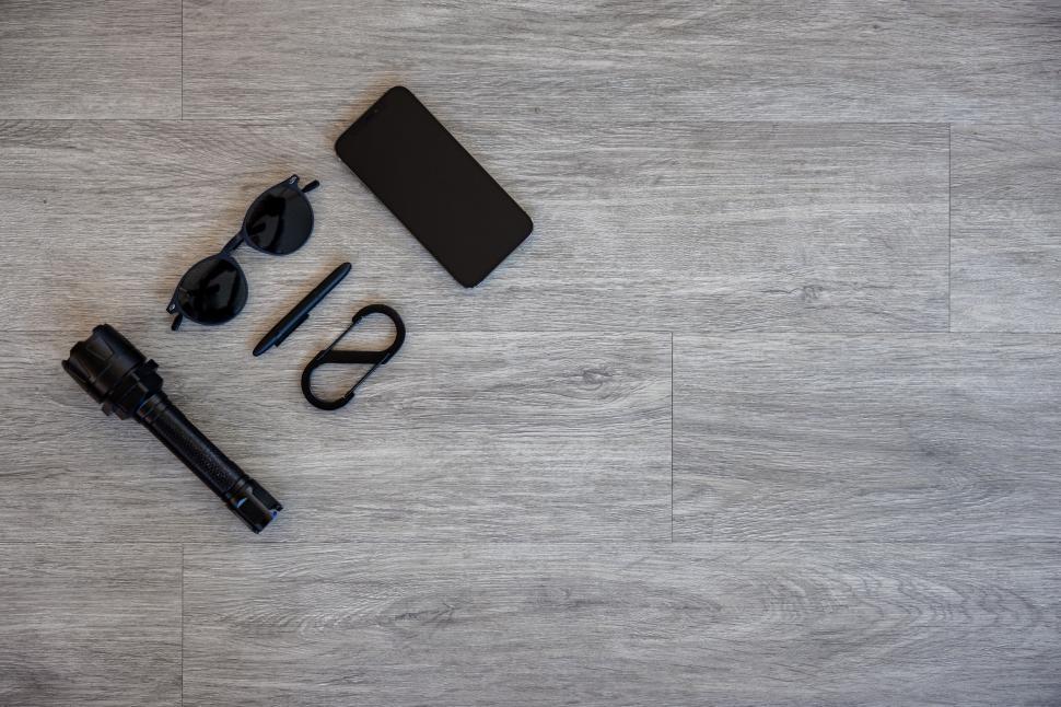 Free Stock Photo of Everyday carry items organized on wood floor ...