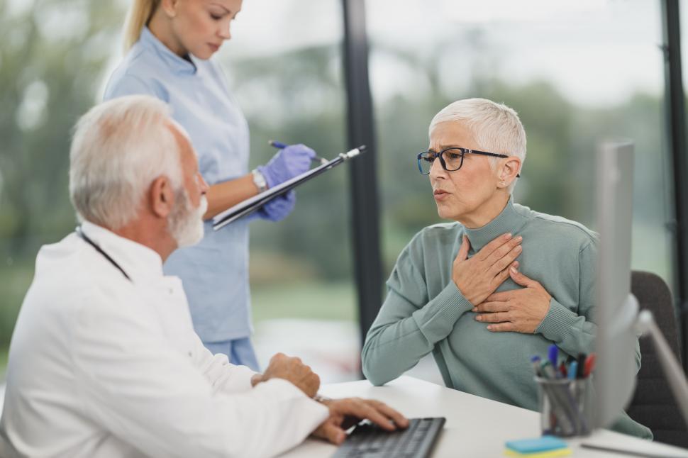 Free Stock Photo of Doctor examines patient with throat discomfort ...