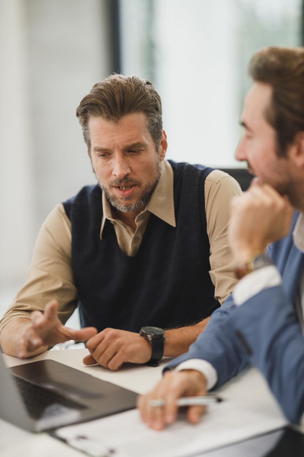 Free Stock Photo of Businessmen discussing over a laptop | Download ...