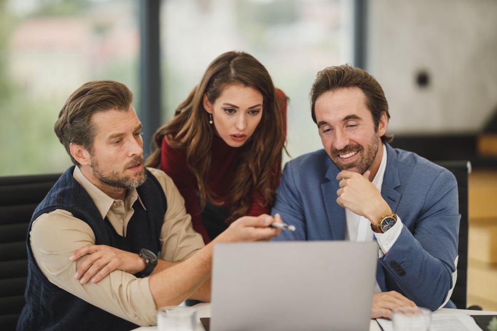 Free Stock Photo of Focused team analyzing data on laptop | Download ...