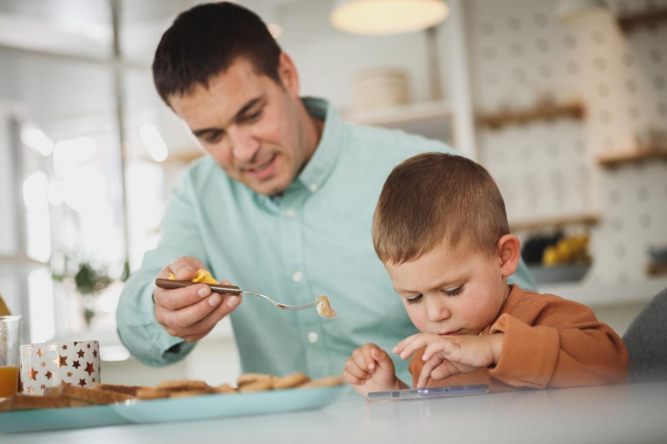 Free Stock Photo of Dad feeding his distracted son | Download Free ...