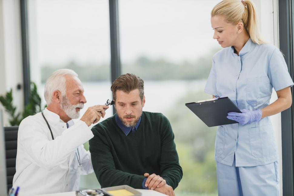 Free Stock Photo of Doctor examining patient with otoscope | Download ...