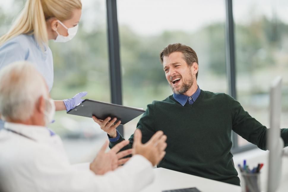 Free Stock Photo of Patient laughing with doctor during checkup ...