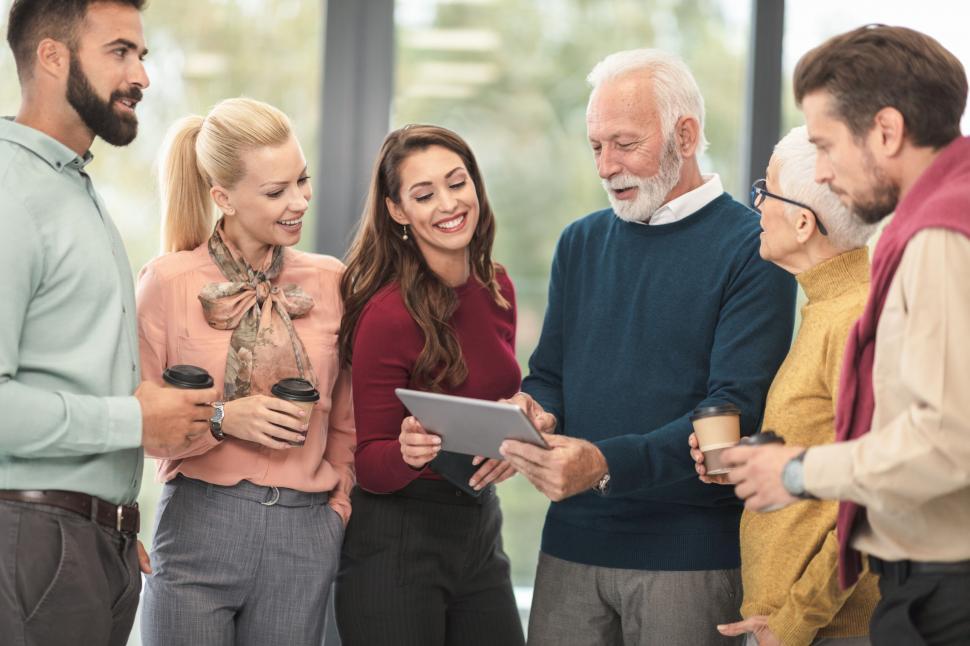Free Stock Photo of Team members sharing a tablet with senior colleague ...