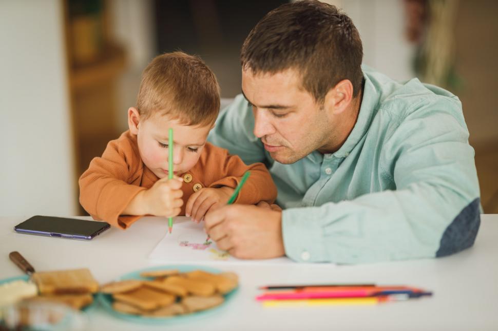 Free Stock Photo of Father helping son with drawing at home | Download ...