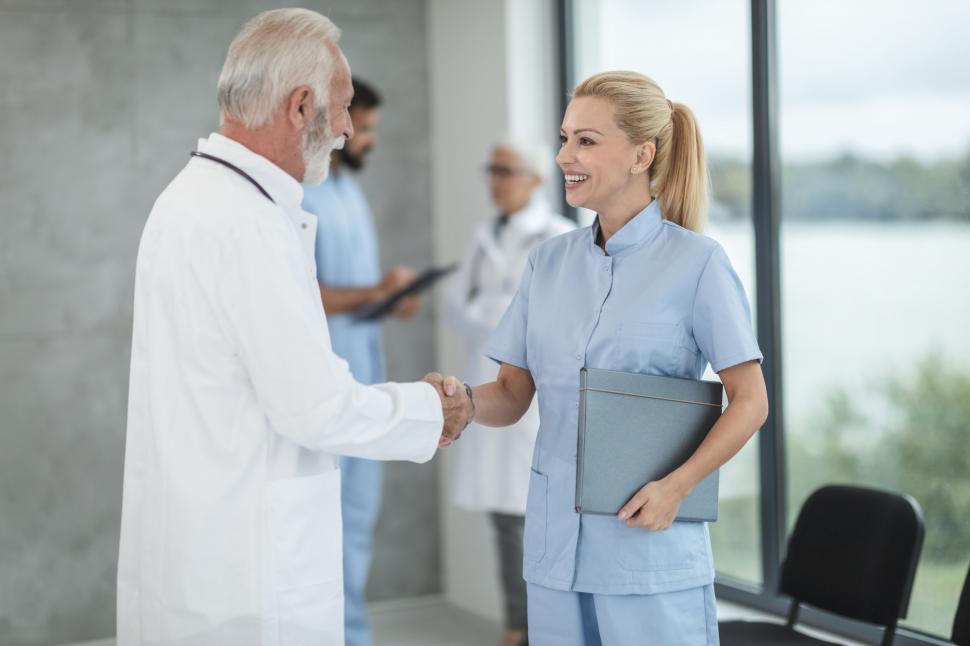 Free Stock Photo of Health professional greeting a senior colleague ...